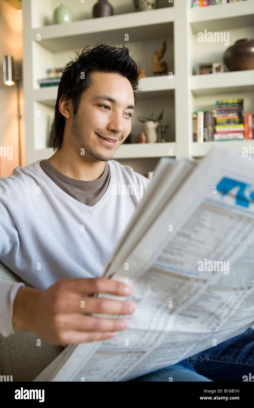 Asian man reading newspaper Stock Photo - Alamy