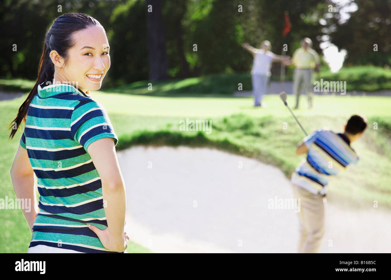 Asian woman on golf course Stock Photo - Alamy