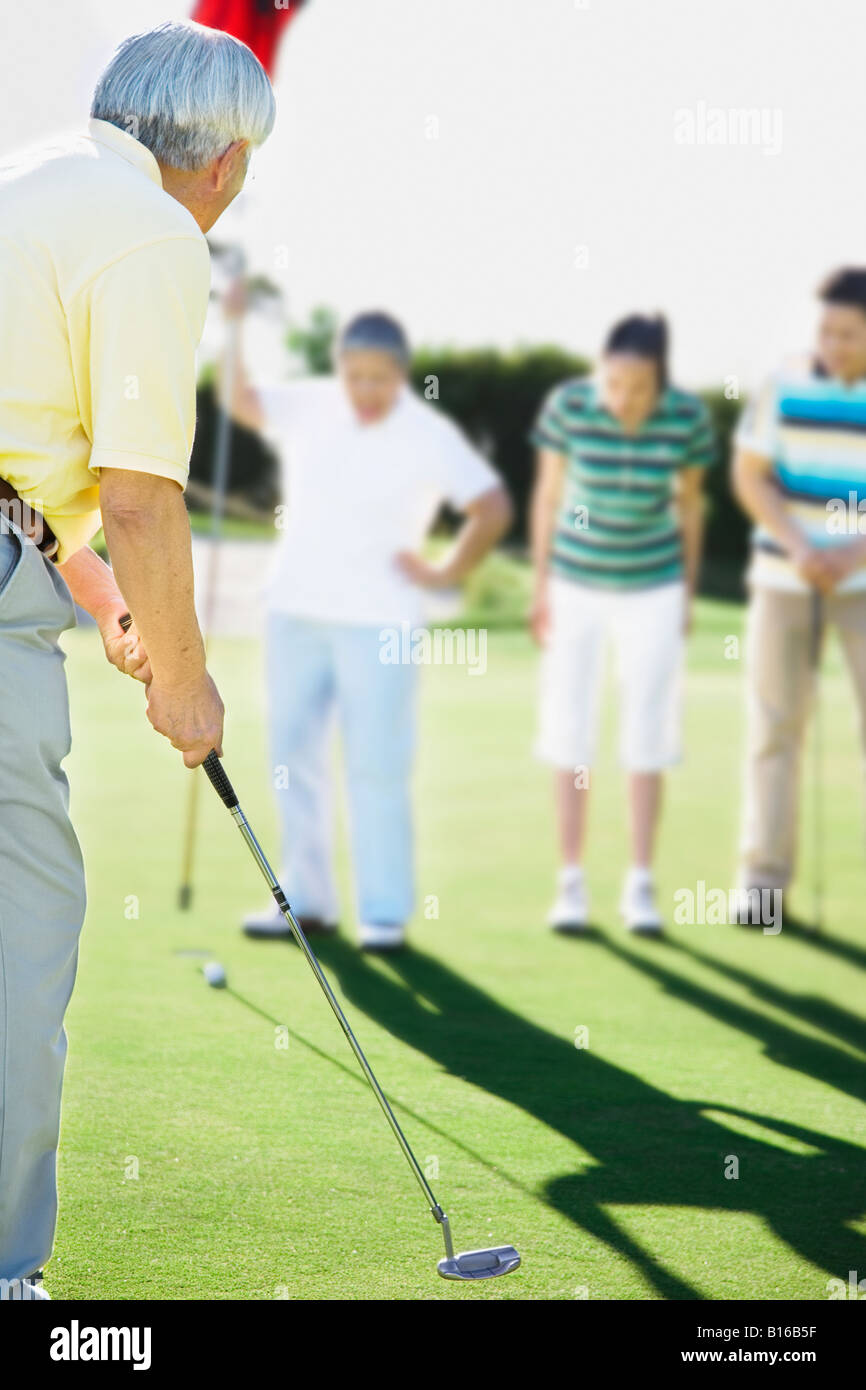Senior Asian man playing golf Stock Photo - Alamy