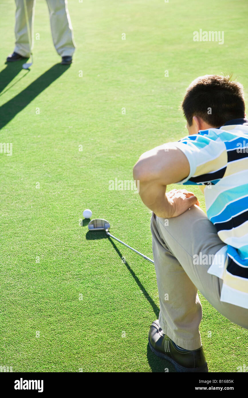 Asian man playing golf Stock Photo - Alamy