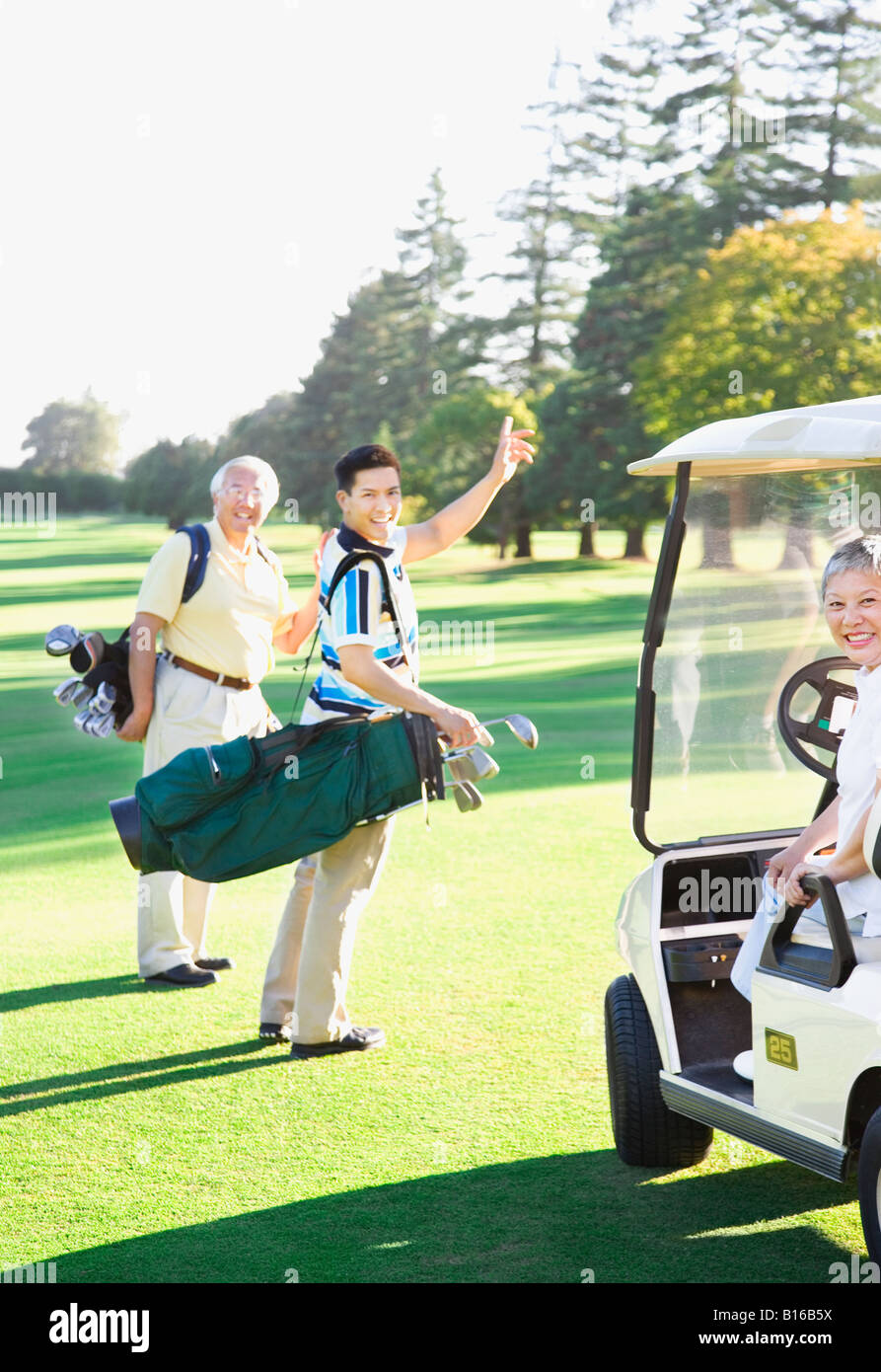 Asian family on golf course Stock Photo - Alamy