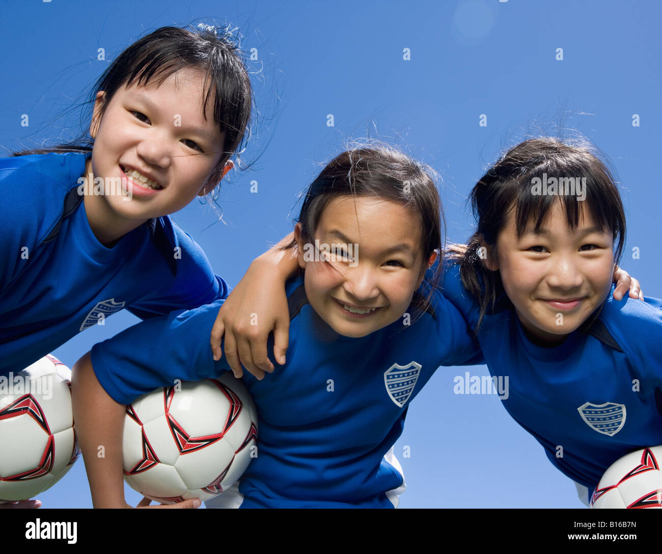 Multi ethnic girls soccer ball blue hi-res stock photography and images ...