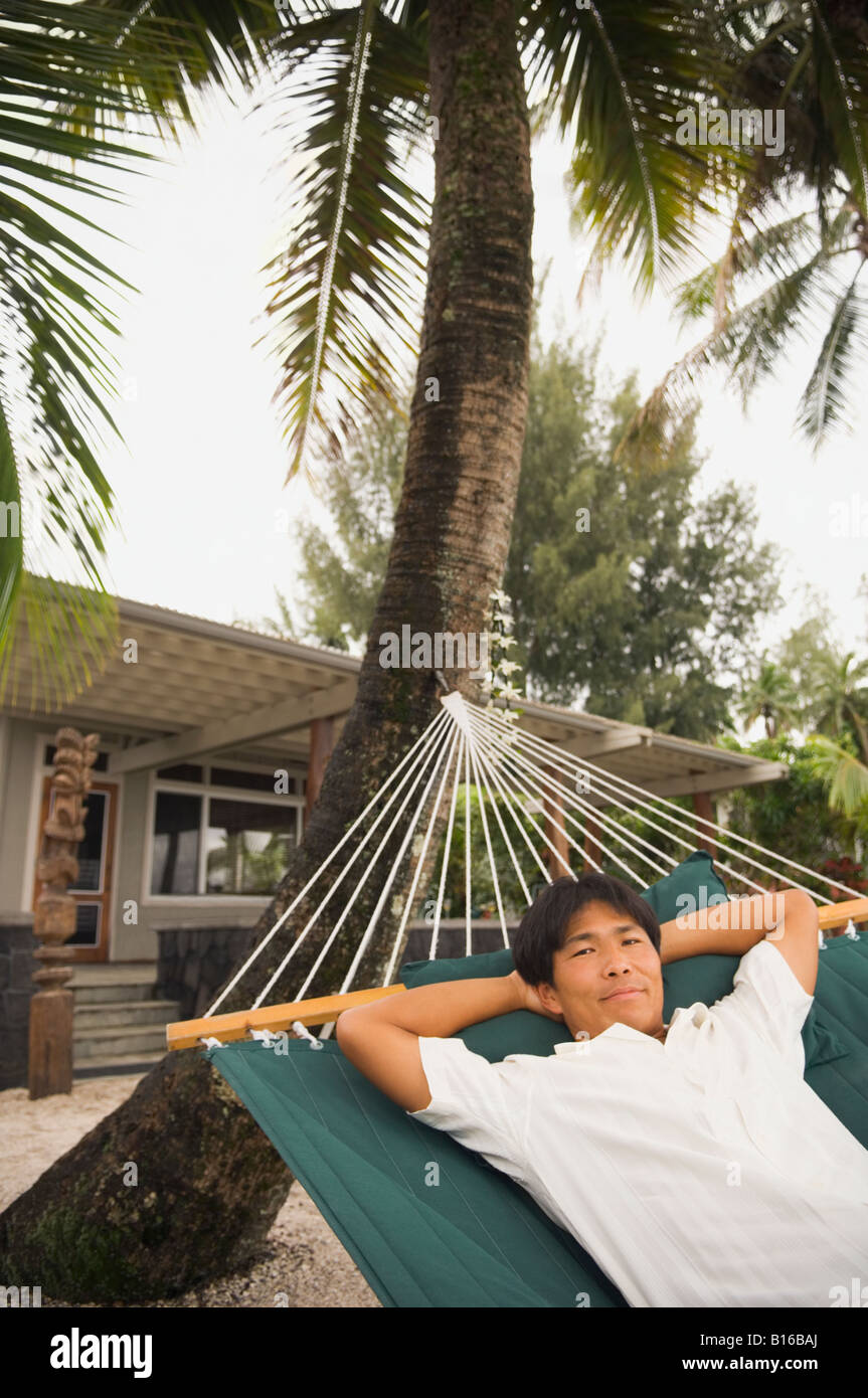 Asian man laying in hammock Stock Photo - Alamy