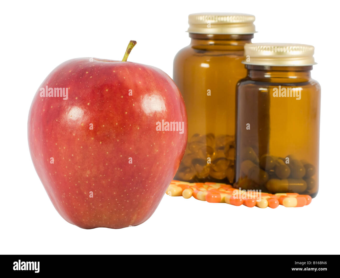 Red apple vs. food supplements in pills Stock Photo - Alamy