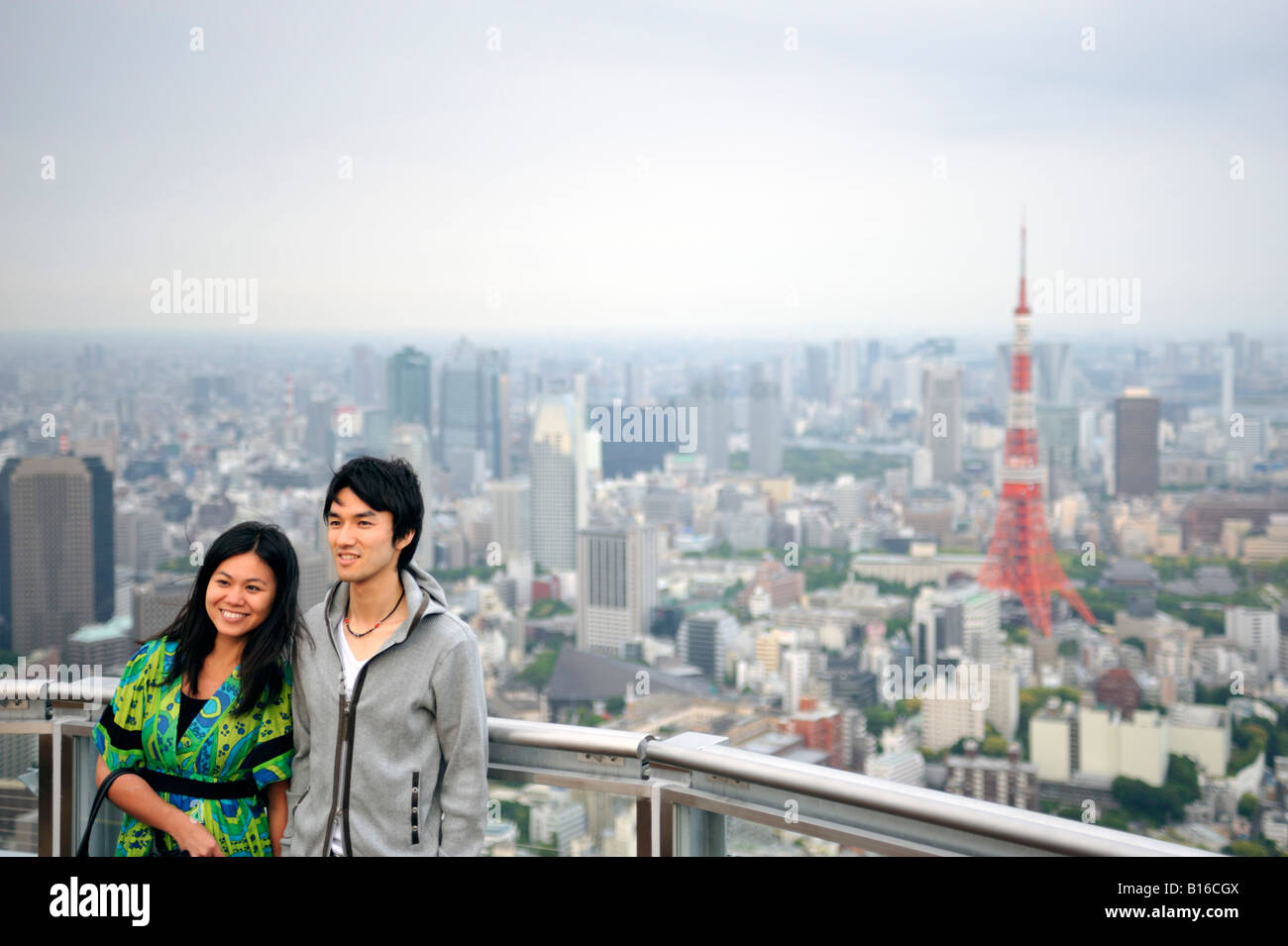 Tourists pose for photograph from Tokyo City view skydeck on roof of ...