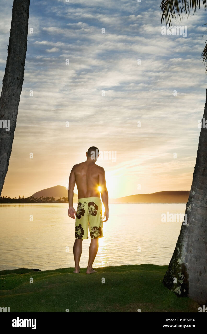 Asian man watching sunset Stock Photo - Alamy