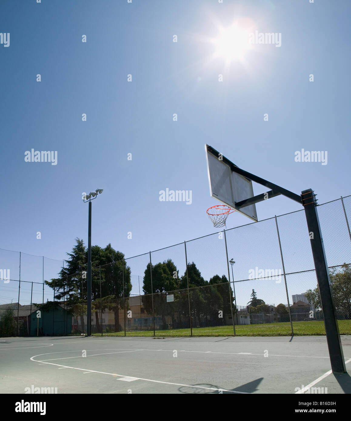 Sun shining on basketball court Stock Photo - Alamy