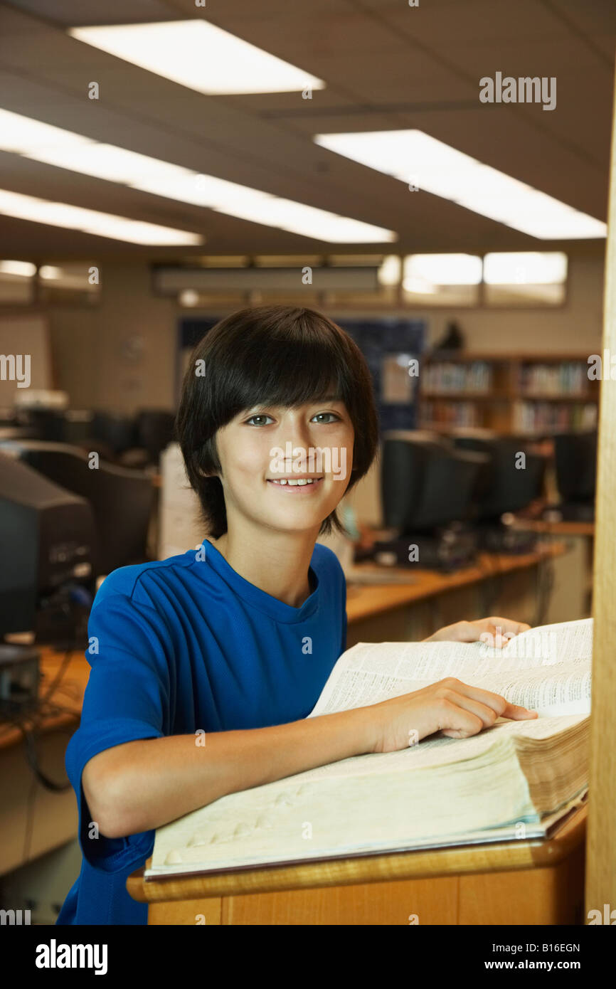 Asian boy using library dictionary Stock Photo - Alamy