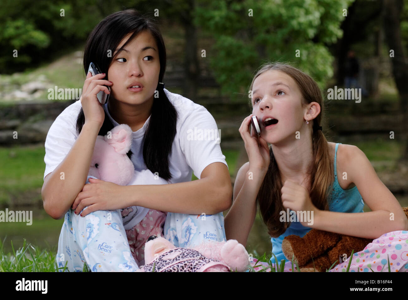 Stock Photograph of two girls talking on cell phones Stock Photo - Alamy