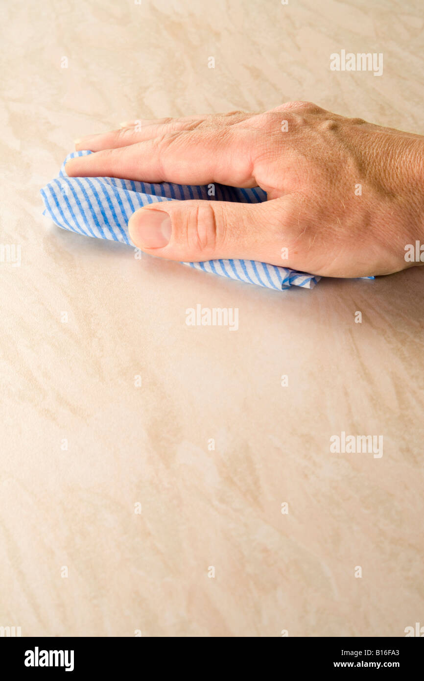 Wiping a kitchen surface with a cloth Stock Photo - Alamy