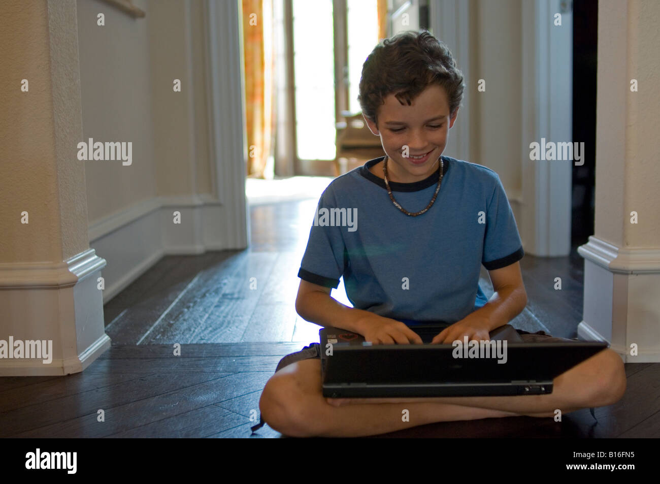 Young boy sitting on Laptop computer Stock Photo - Alamy