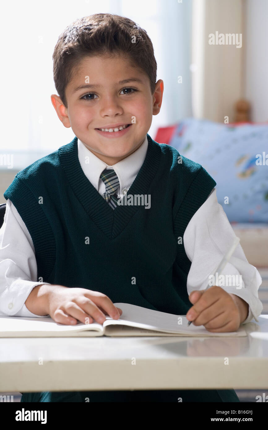 Hispanic boy writing in notebook Stock Photo - Alamy