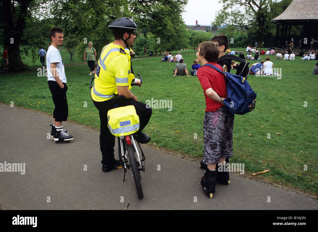 A Community Police Officer On A Bike Talking To Young People In Leek ...