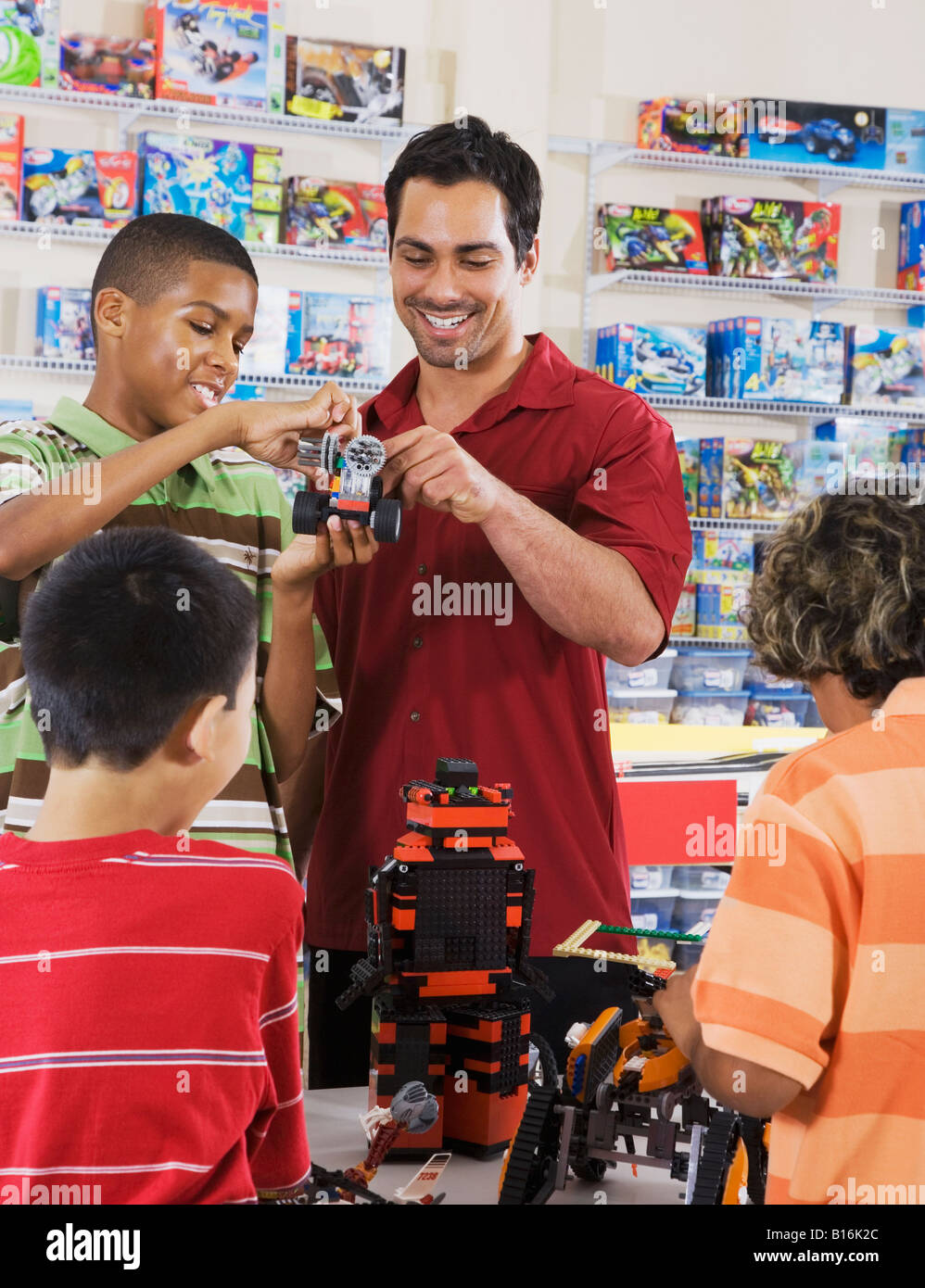 Multi-ethnic children playing in toy store Stock Photo - Alamy