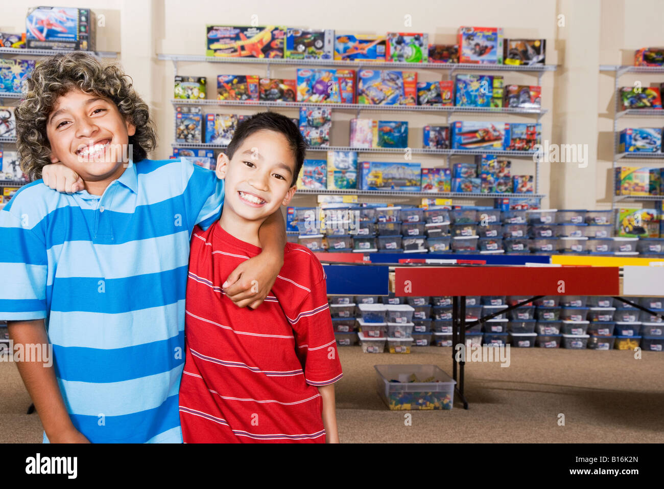Multi-ethnic boys hugging Stock Photo - Alamy