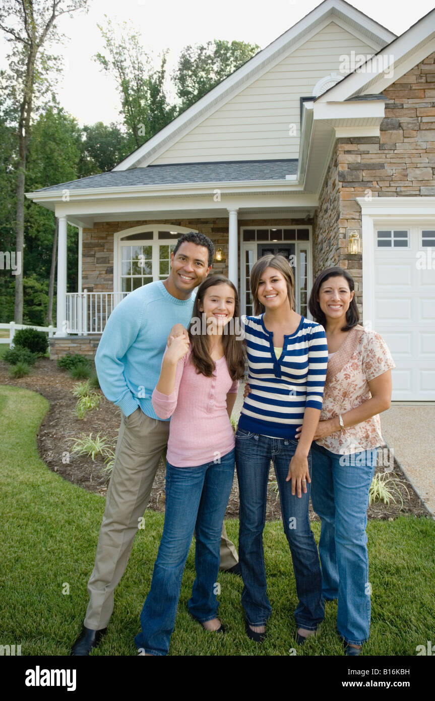 Hispanic family in front of house Stock Photo - Alamy