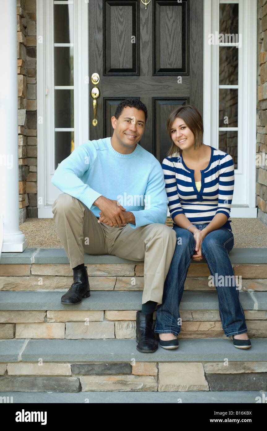 Hispanic father and daughter sitting on porch steps Stock Photo - Alamy