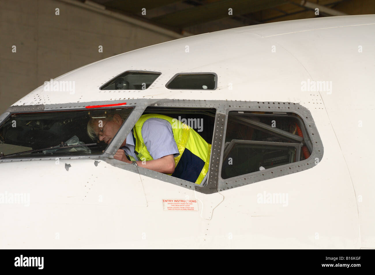Airliner engineer working on jet maintenance Boeing 737 airliner ...