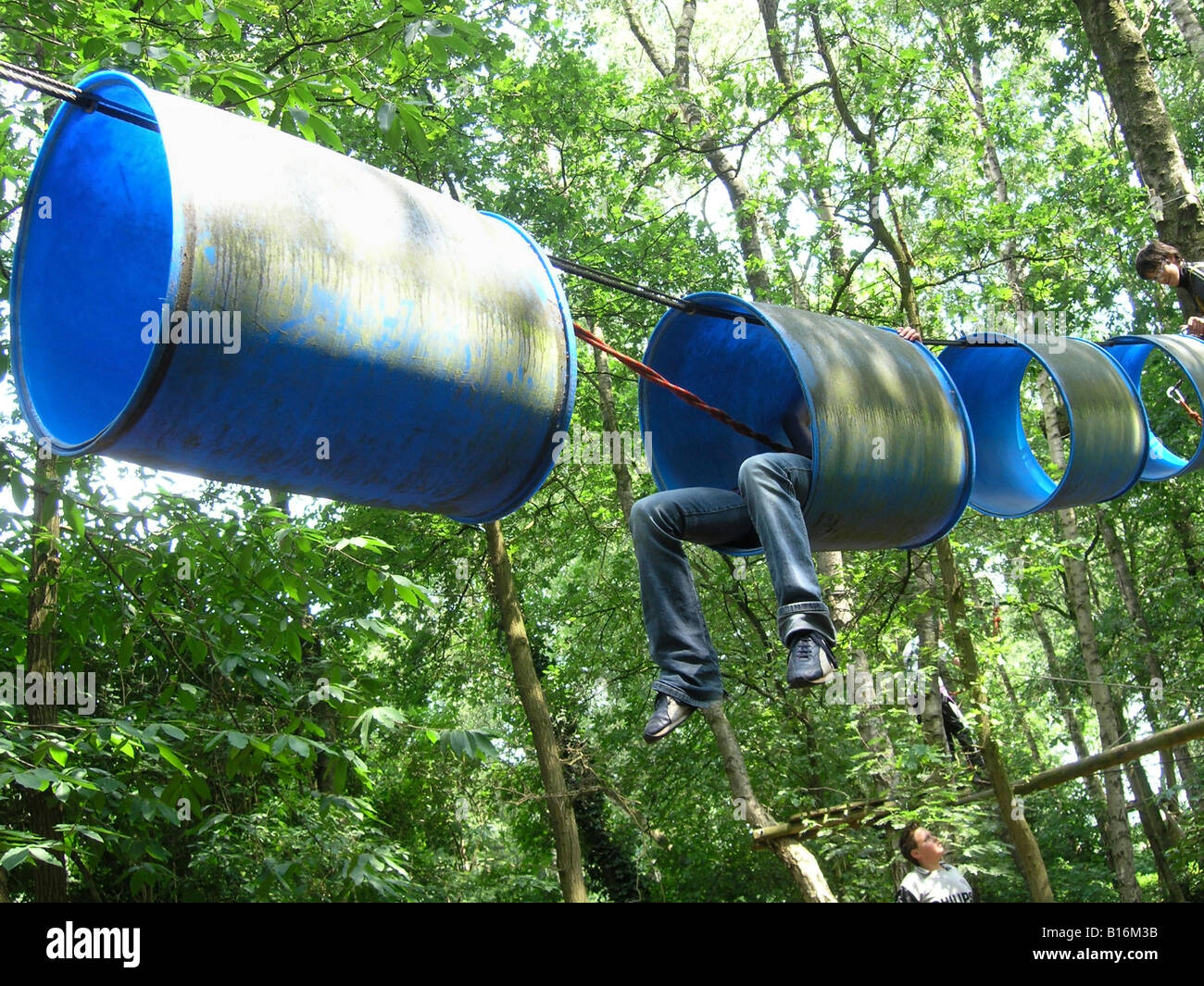 student climbing through obstacle at school camp Stock Photo - Alamy