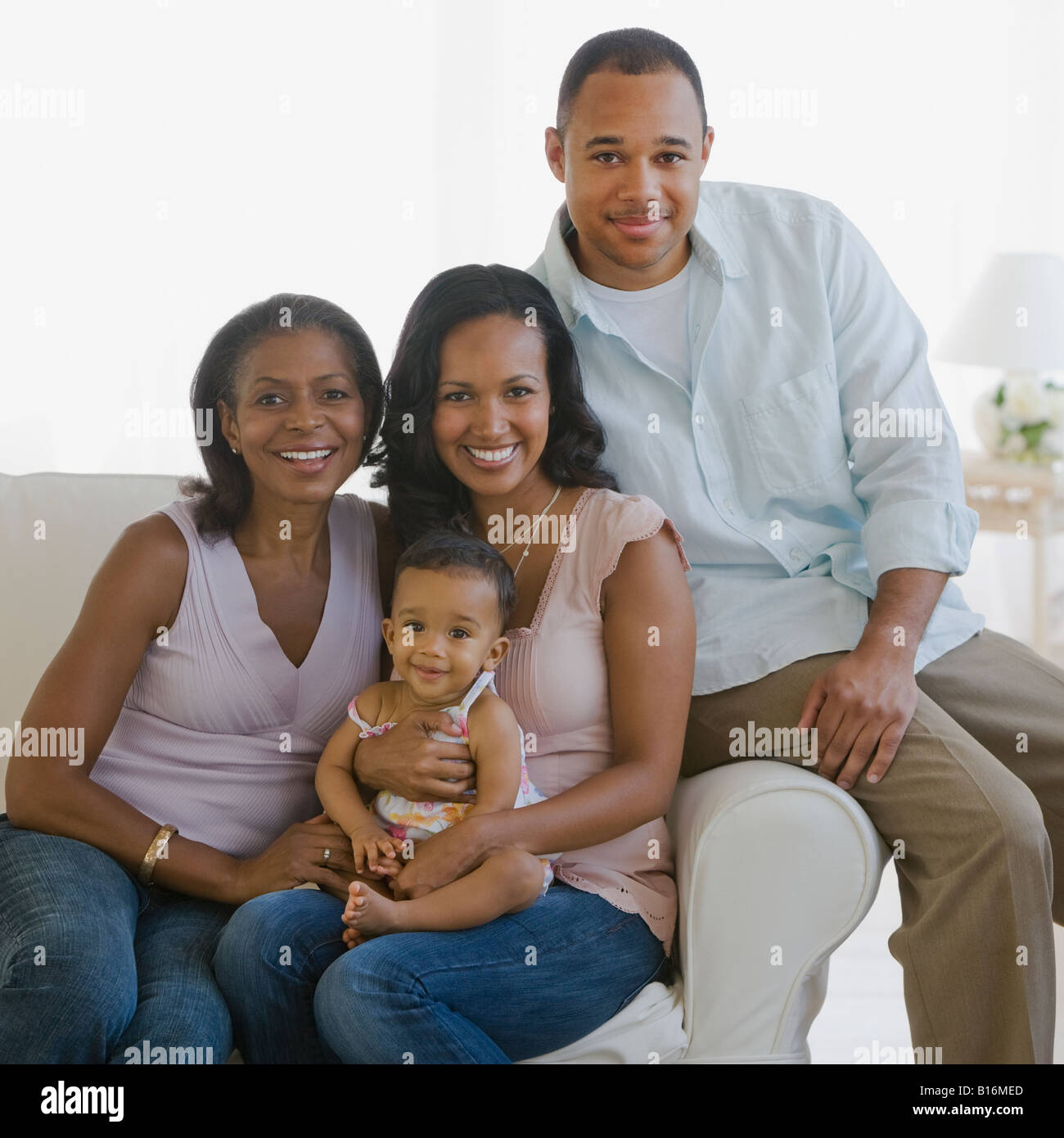 Multi-generational African American family on sofa Stock Photo - Alamy