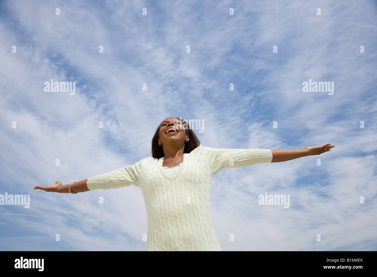African American woman with arms outstretched Stock Photo - Alamy