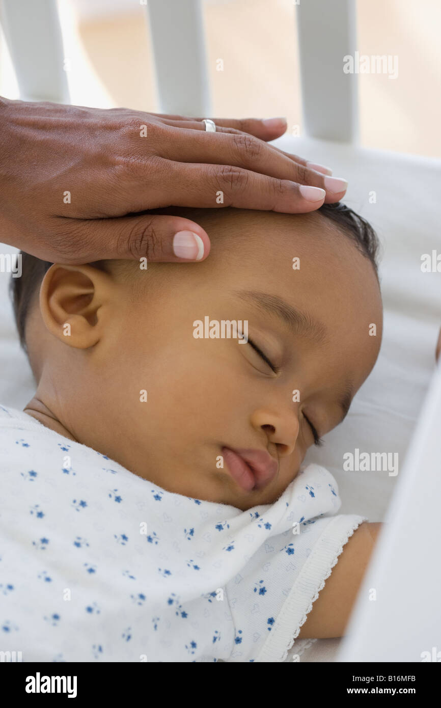 African American baby sleeping in crib Stock Photo - Alamy