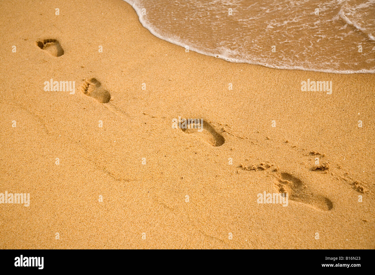 Footsteps on the beach at Managlore, Karnataka. The beach is pleasantly ...