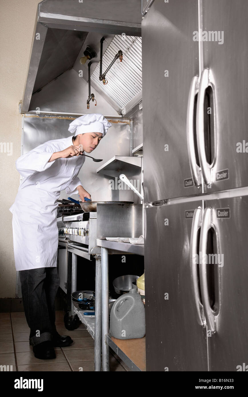 Asian male chef tasting food Stock Photo - Alamy