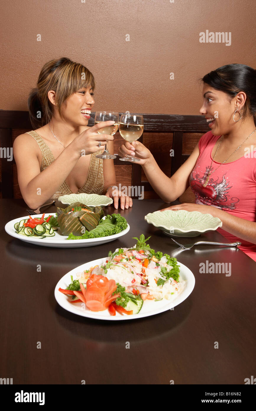 Multi-ethnic women toasting at restaurant Stock Photo - Alamy