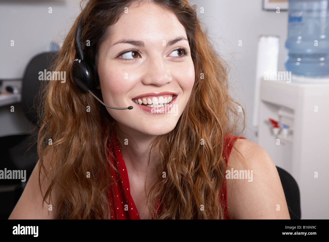 Hispanic businesswoman wearing headset Stock Photo - Alamy