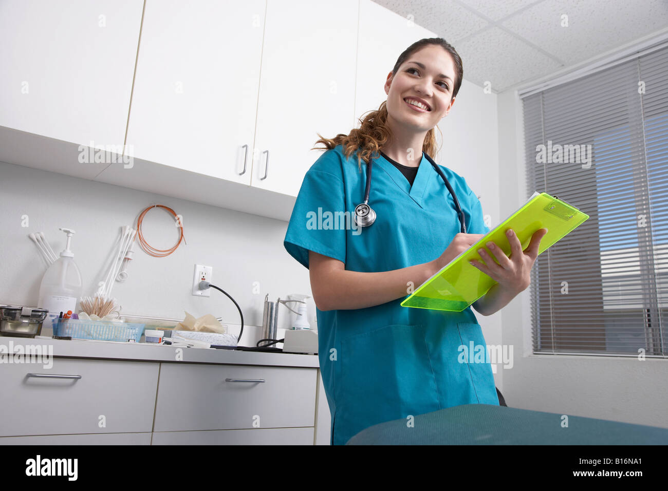 Hispanic female medical professional holding chart Stock Photo - Alamy