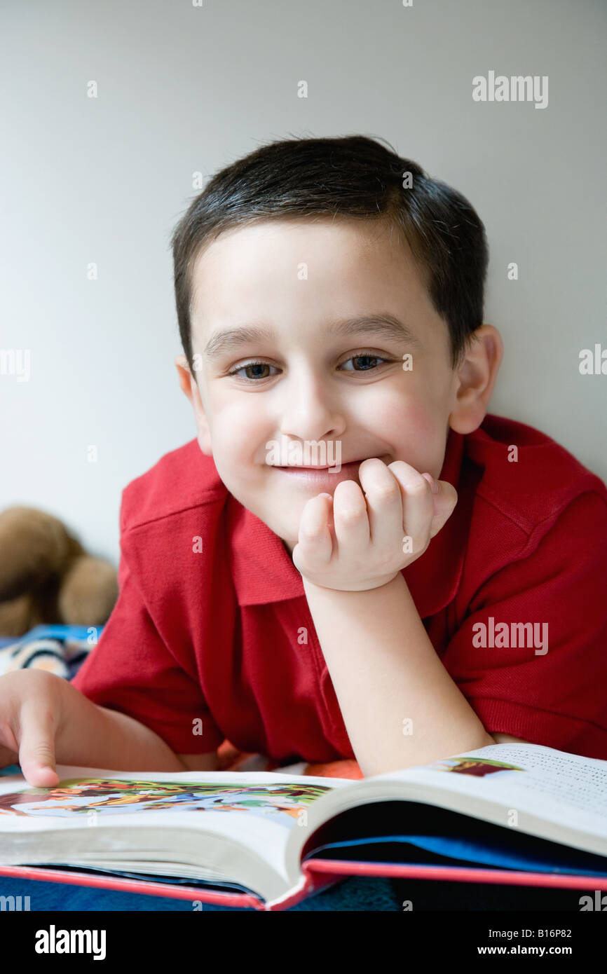 Hispanic boy reading book laying happy hi-res stock photography and ...
