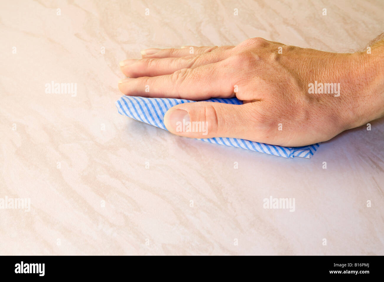 Wiping a kitchen surface with a cloth Stock Photo - Alamy