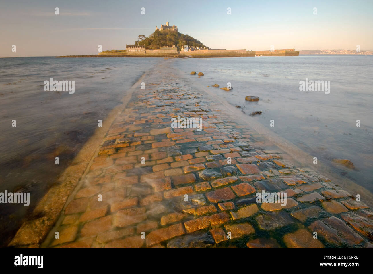 Waves rushing over the the old stone causeway leading to St Michaels ...