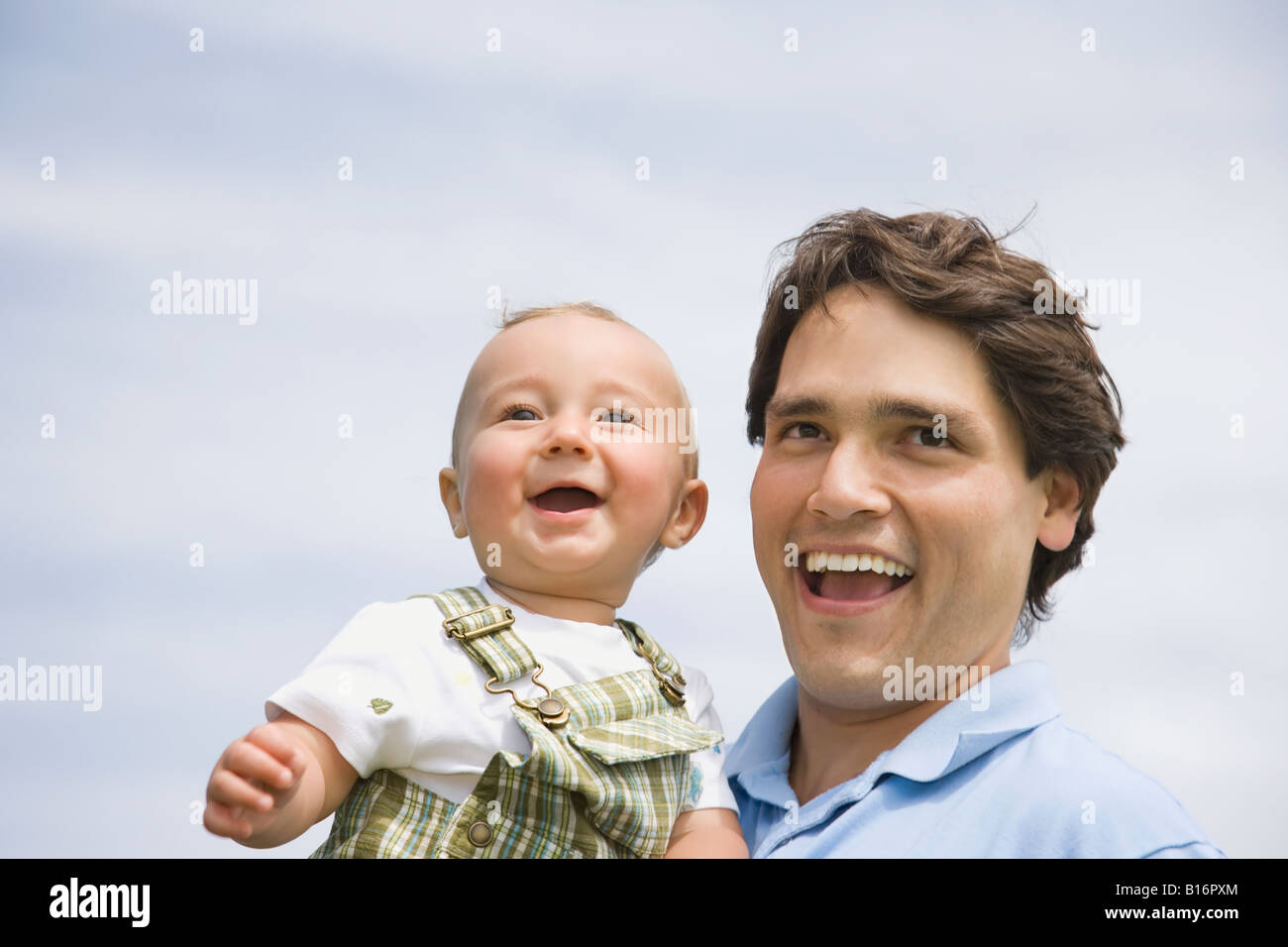 Hispanic father holding baby Stock Photo - Alamy