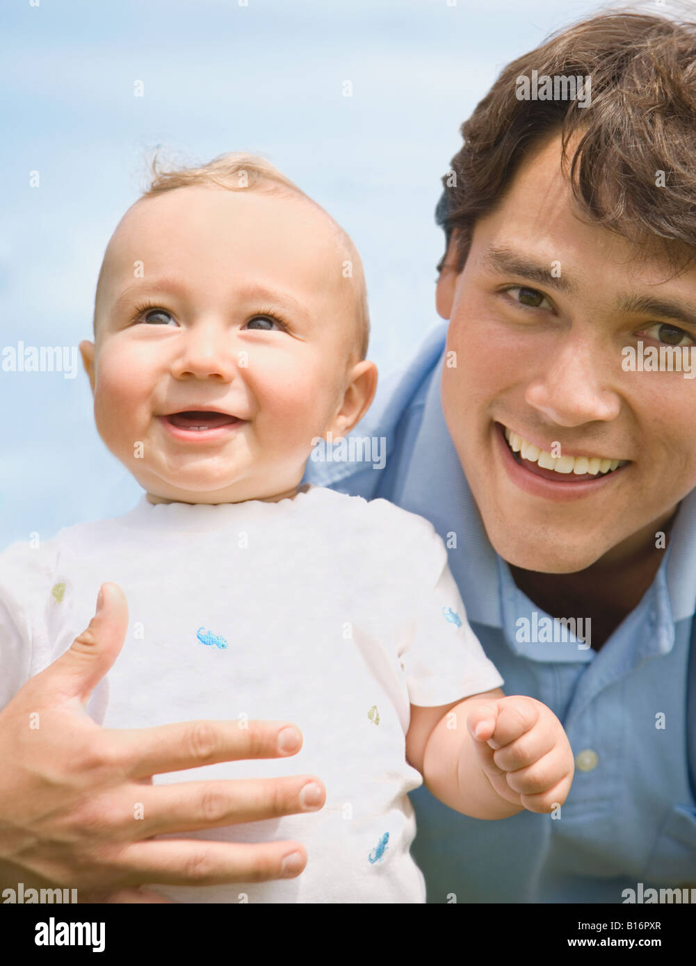 Hispanic father holding baby Stock Photo - Alamy
