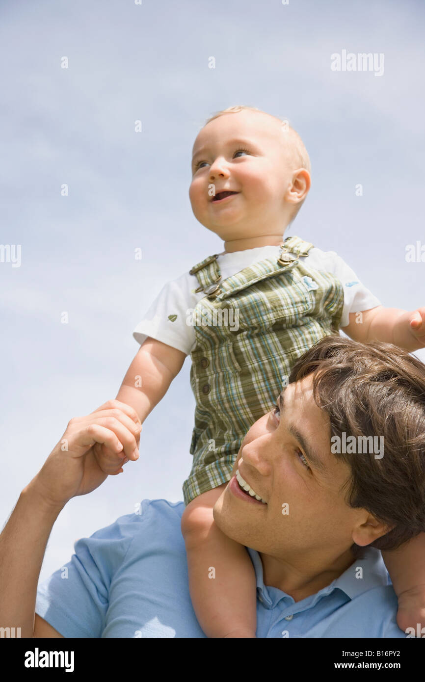 Hispanic father holding baby on shoulders Stock Photo - Alamy