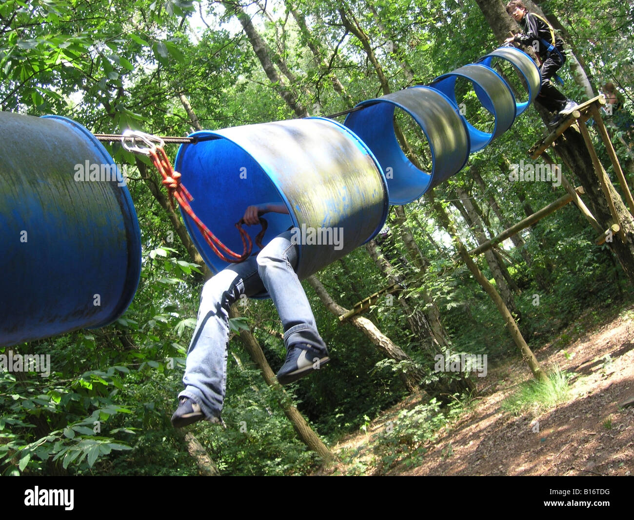 student climbing through obstacle at school camp Stock Photo - Alamy
