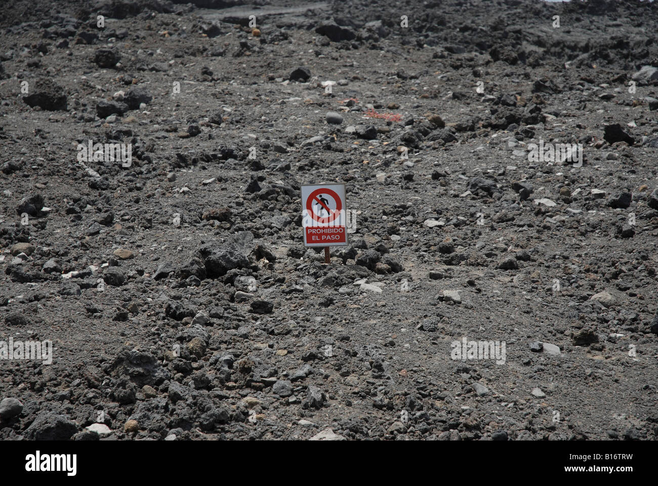 A warning sign not to walk on the thick crust of lava covering the ...