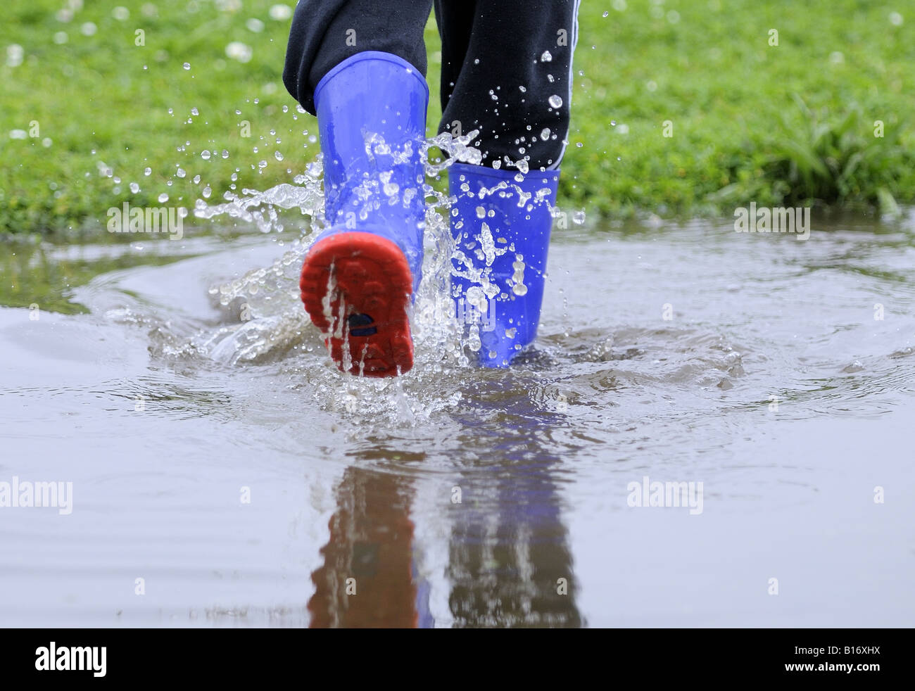 Boy in wellington boots in a puddle Stock Photo - Alamy