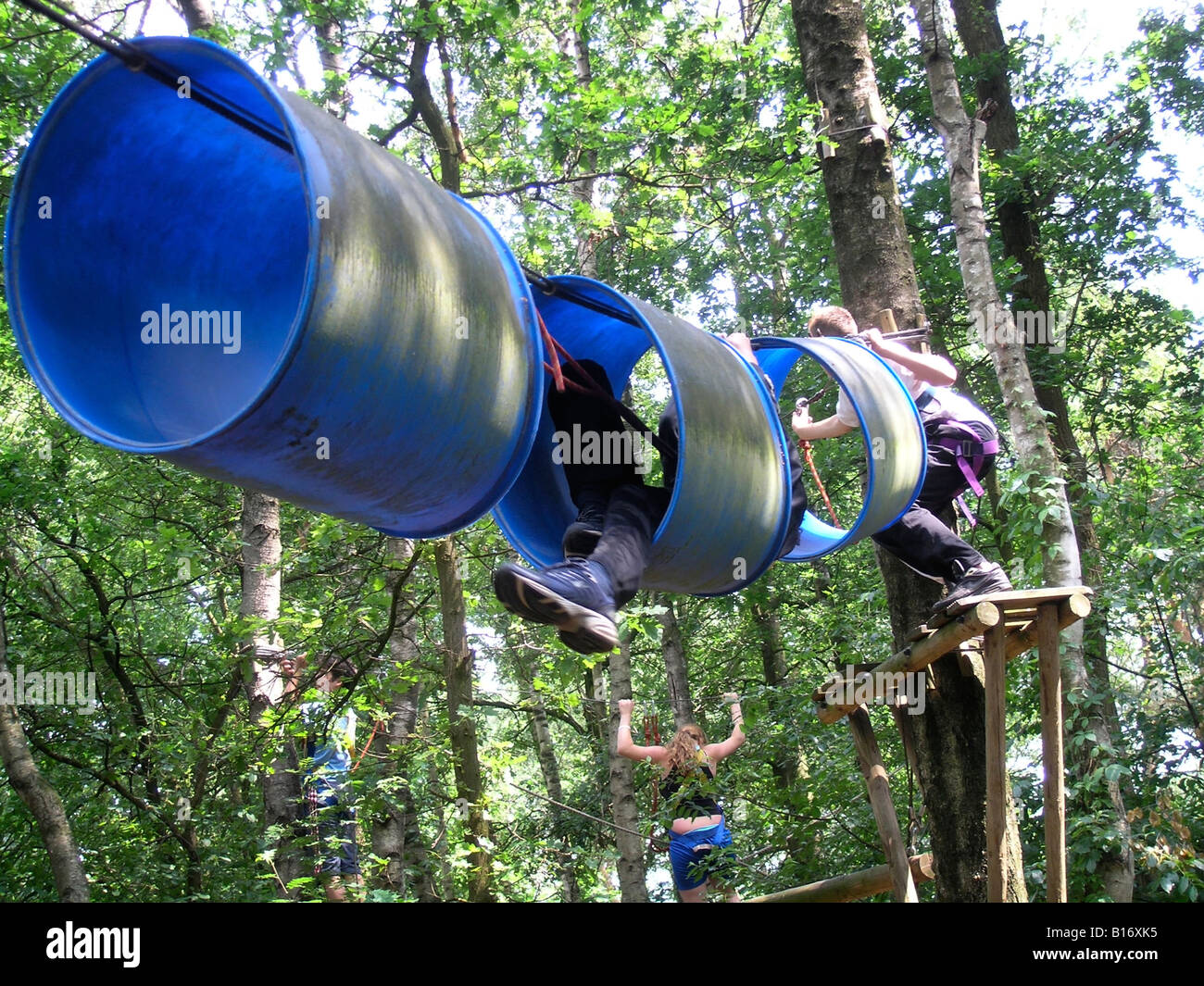 student climbing through obstacle at school camp Stock Photo - Alamy