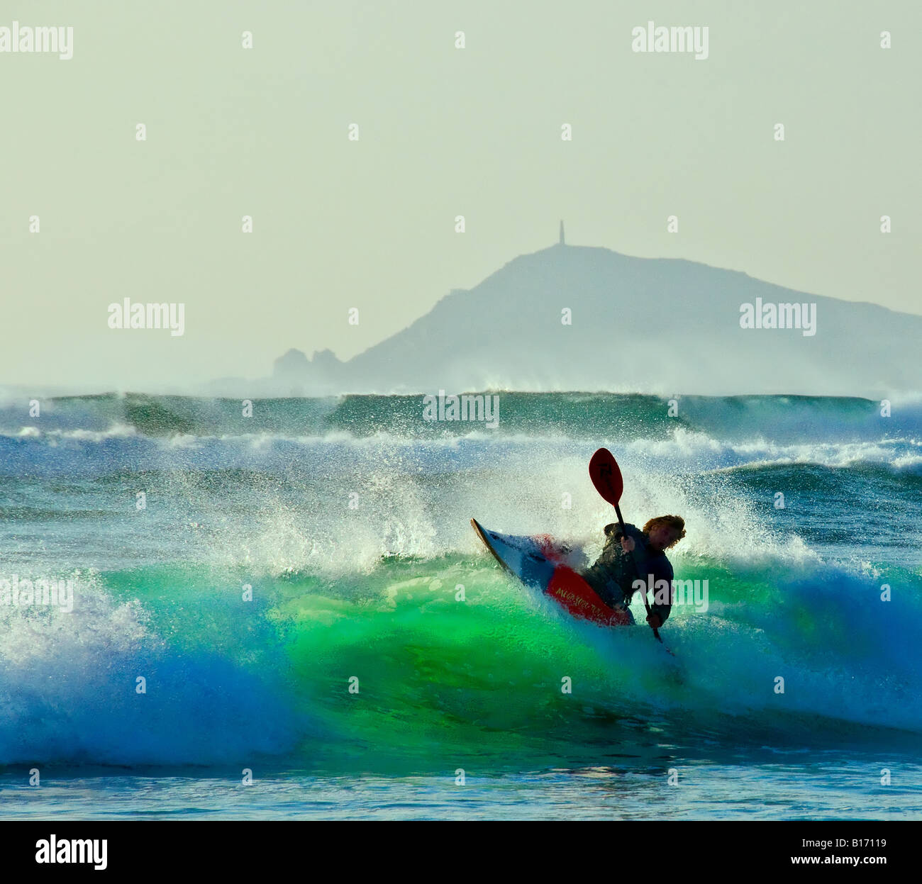 Surf kayaking as the sun sets at Sennen in Cornwall Stock Photo - Alamy