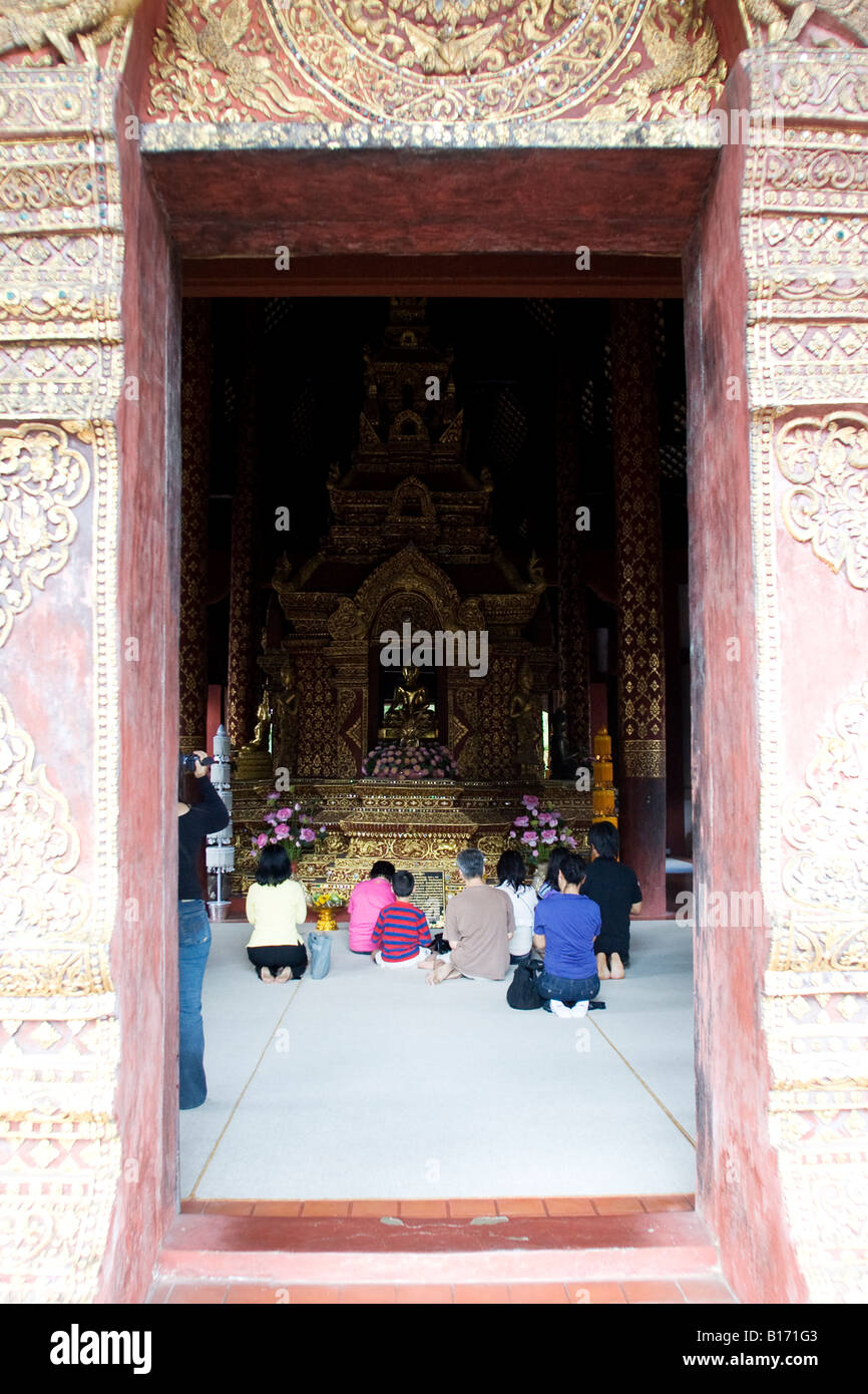 a group of people pray at a temple Stock Photo - Alamy