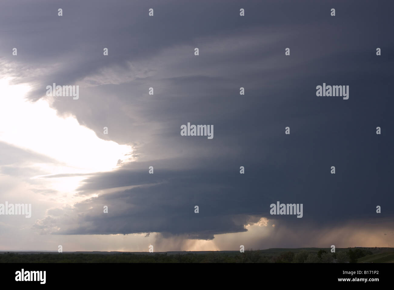 Evening cumulonimbus clouds with developing thunderstorm and rain with ...