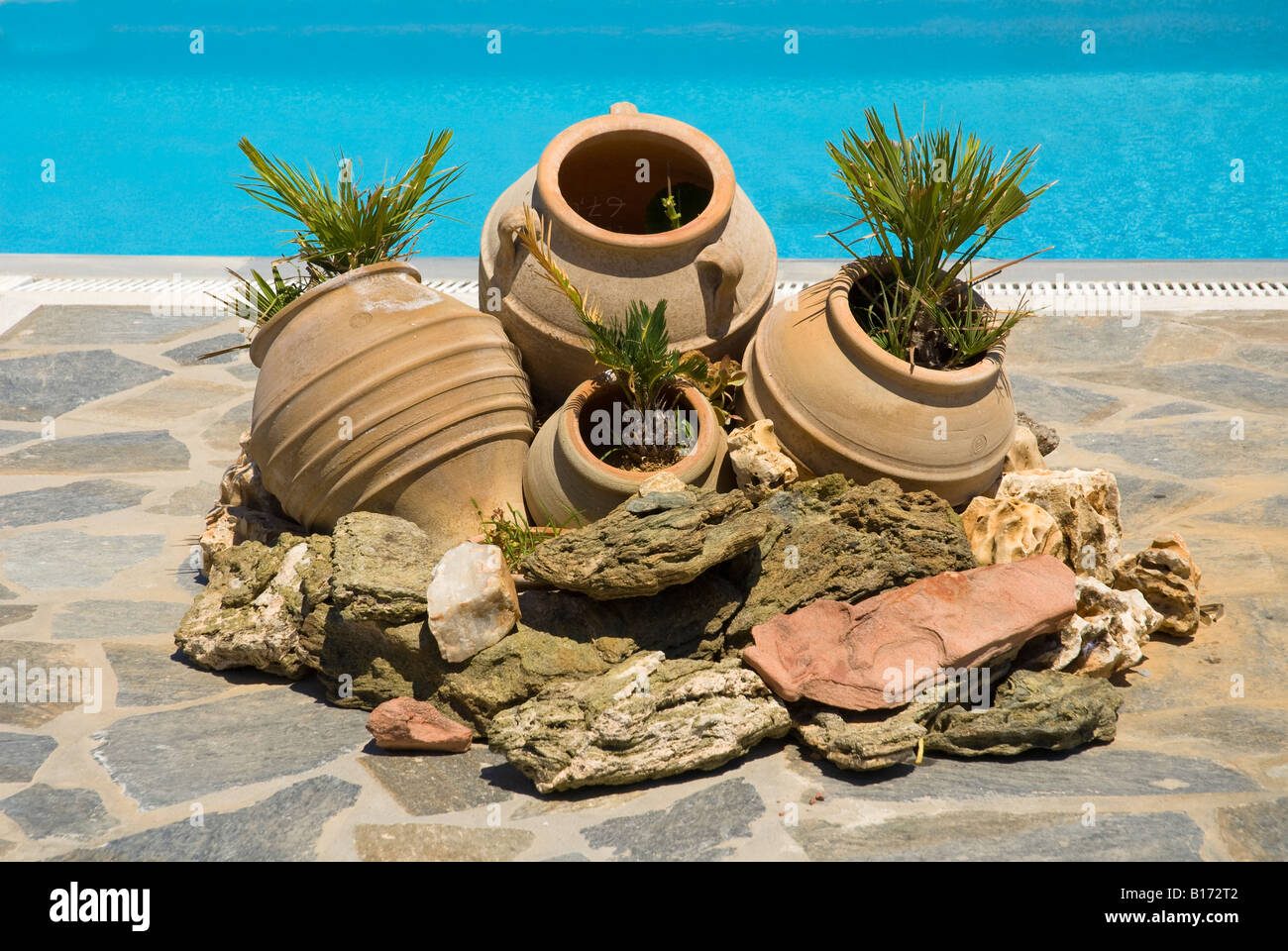 A courtyard display of terra cotta pots at a Country Club Pachia Ammos ...