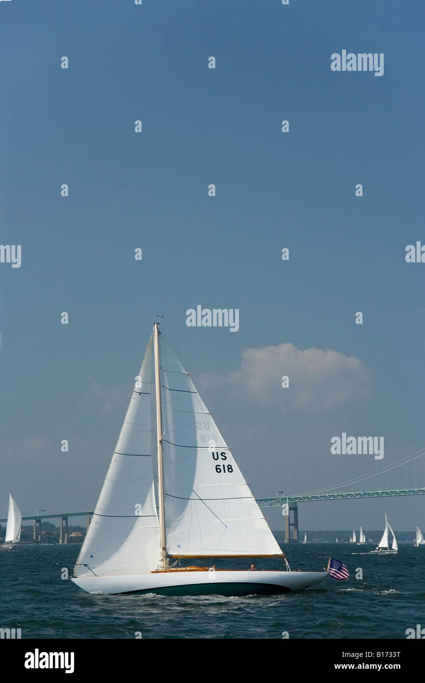 Photo of a classic sail boat sailing in open water with sailboats and ...