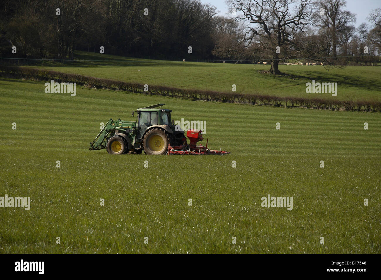 Tractor power harrowing a Field Stock Photo - Alamy