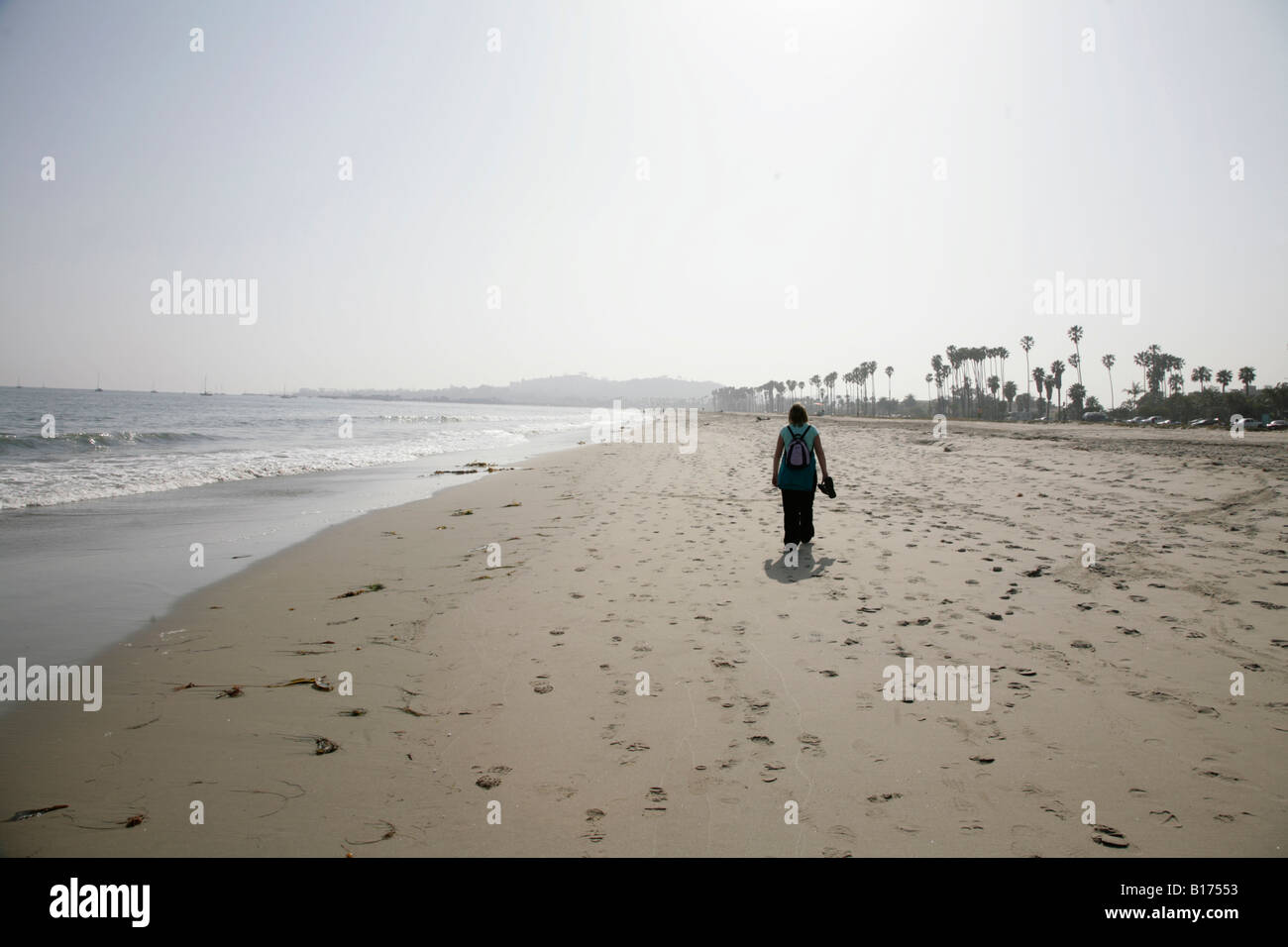 Lone person walking on a deserted beach in California Stock Photo - Alamy