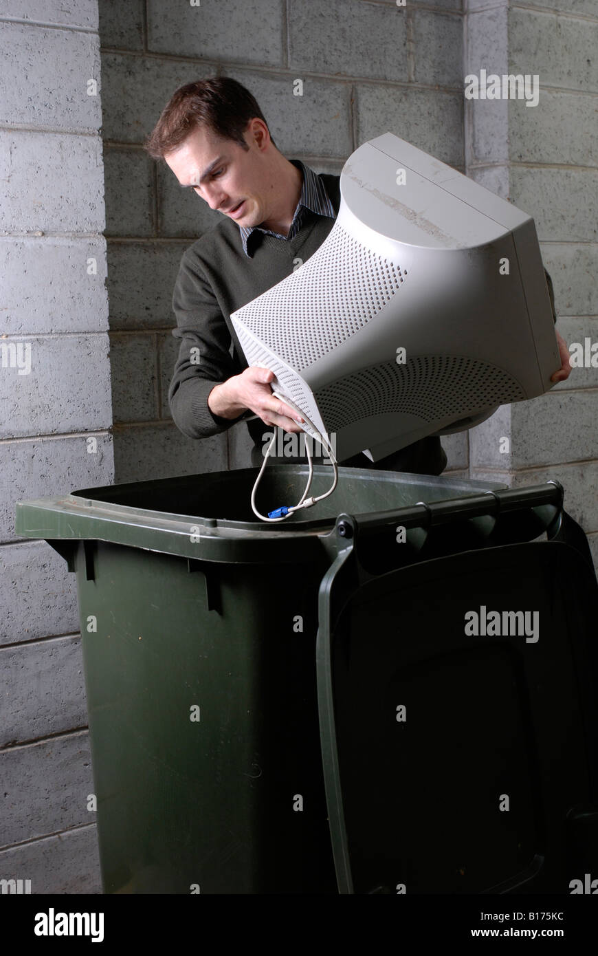 Disposing of obsolete computer technology in a wheelie bin Stock Photo ...