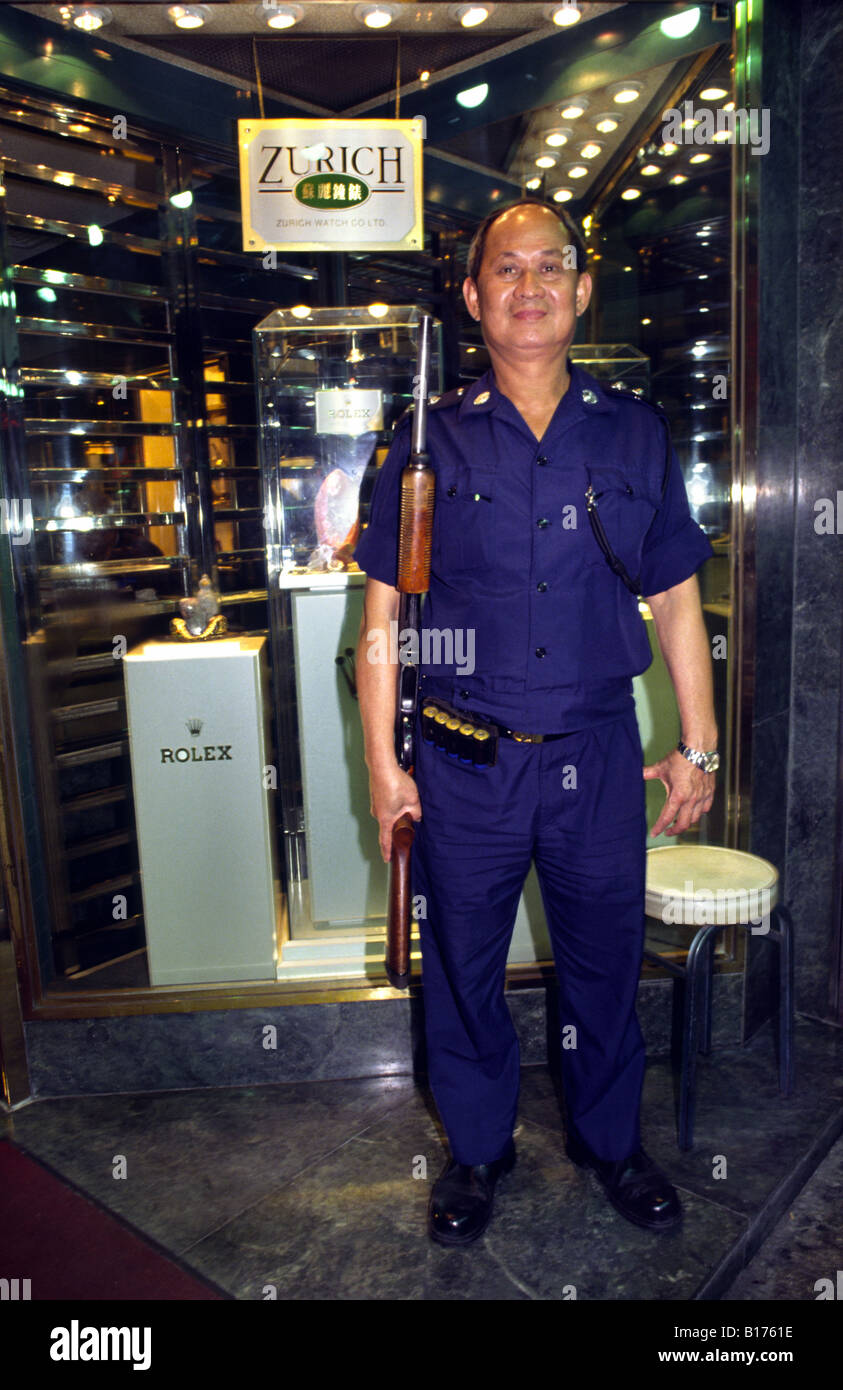 Security guard with shotgun. Kowloon, Hong Kong, China Stock Photo - Alamy